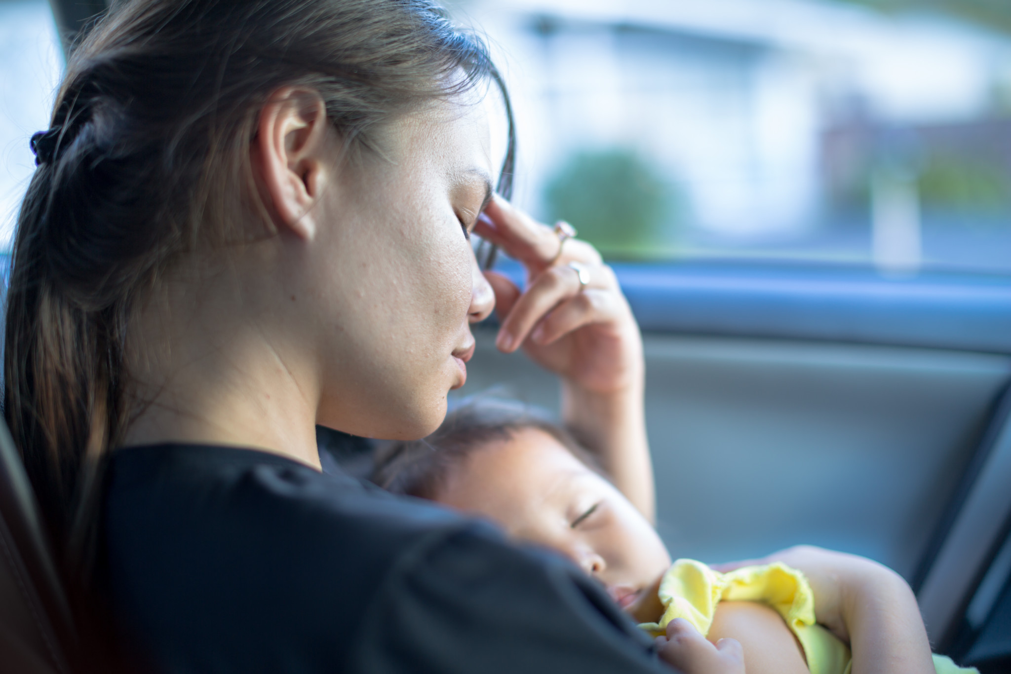 Tired stressed mother holding baby - School Mum